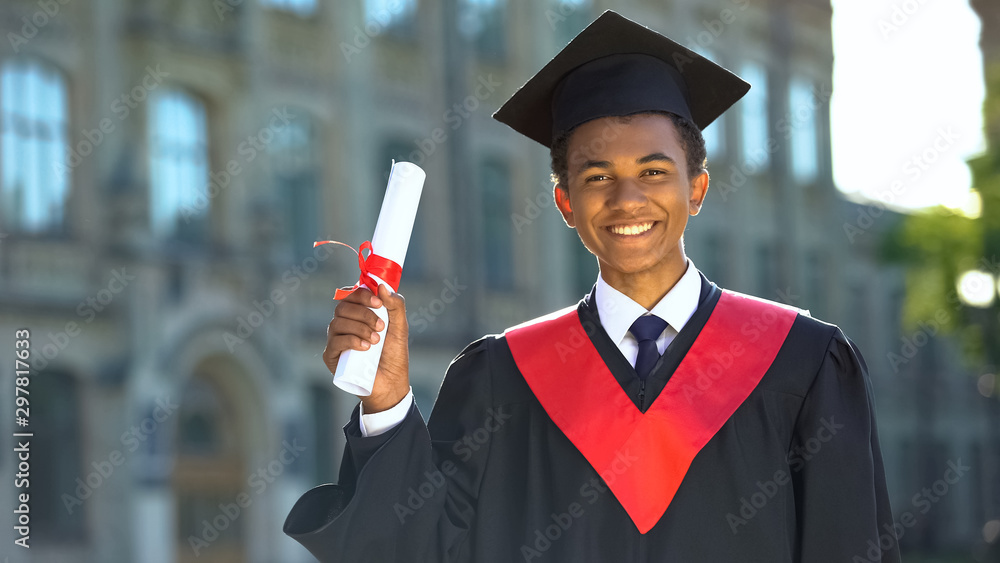 Joyful college student showing diploma celebrating graduation day ...