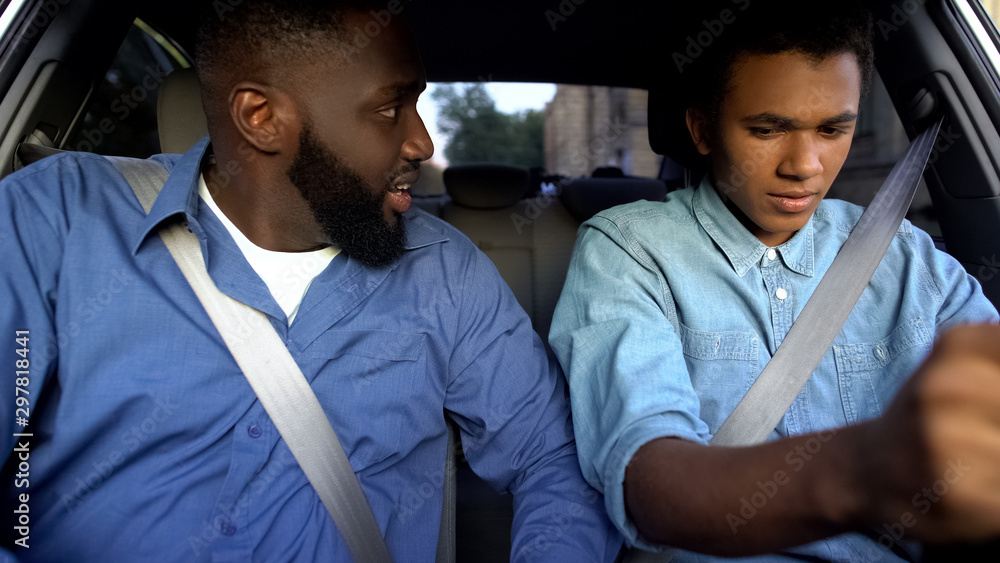 Angry dad screaming at scared teenage son driving car, child upbringing ...