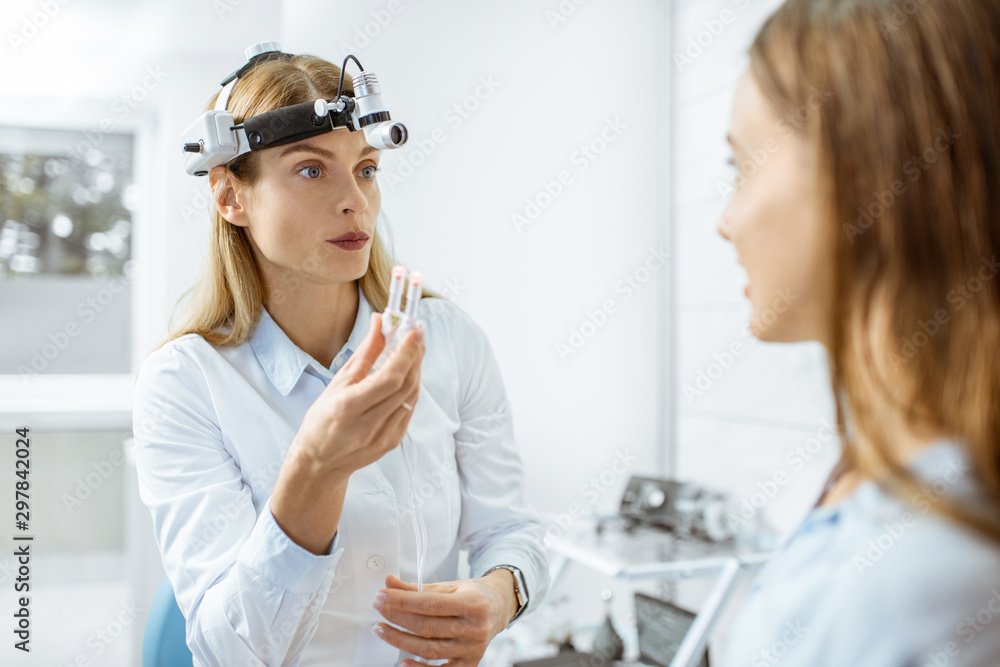 Beautiful female otolaryngologist preparing for the physiotherapy ...