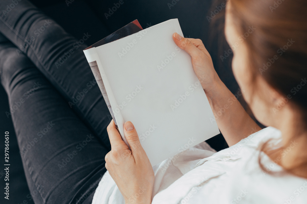 Beautiful female hands hold an open book or magazine in the room Stock ...