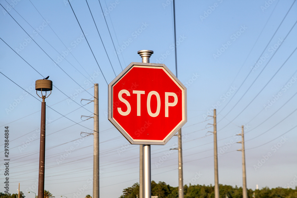 Signpost, sign, stop, in the middle of electricity pylons and wires in ...