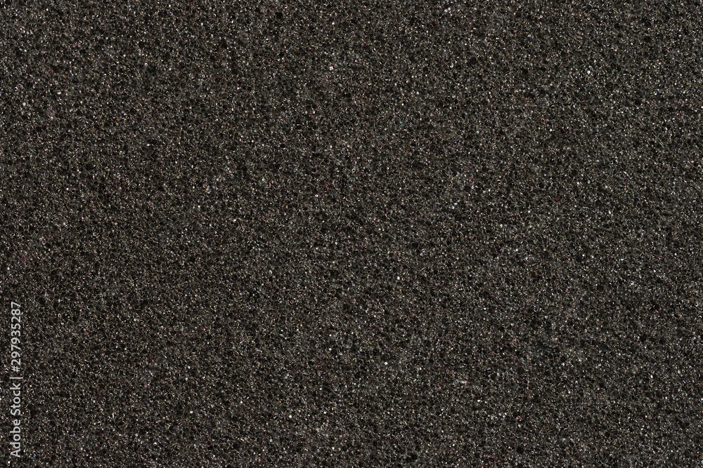Black foam rubber background. Soundproofing material, dark grain ...