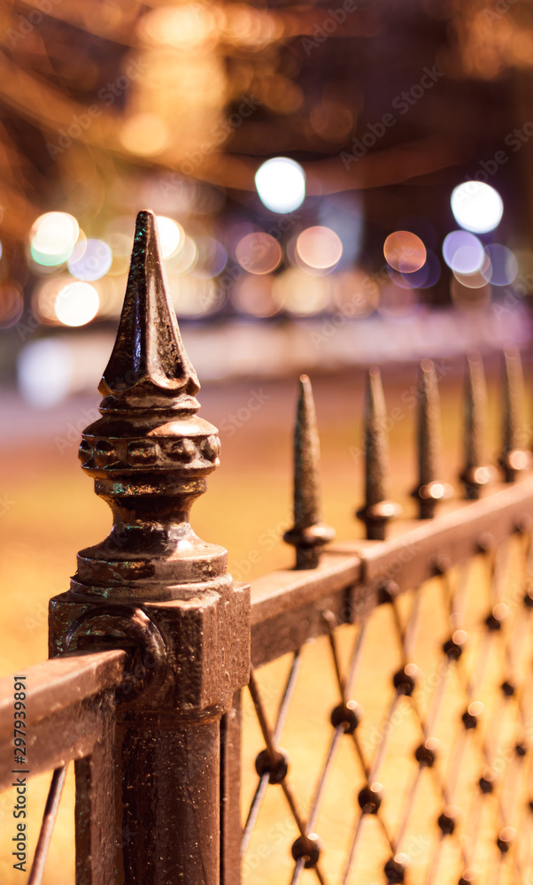 Beautiful texture fence with decorative elements at night in warm light ...