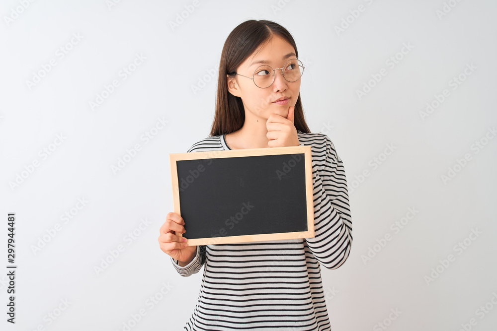 Young chinese woman wearing glasses holding blackboard over isolated ...