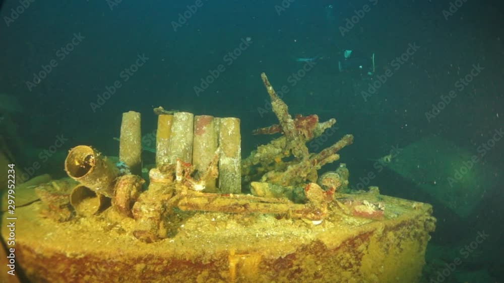 Diver inside hull of sunken ship underwater of Pacific Ocean on Chuuk ...