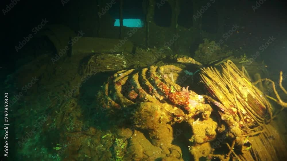Diver inside hull of sunken ship underwater of Pacific Ocean on Chuuk ...