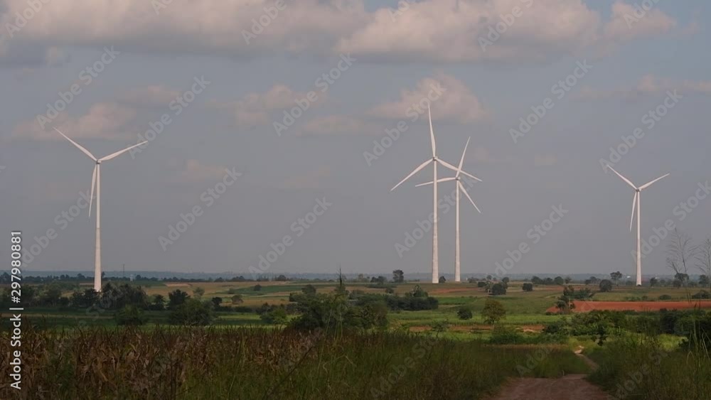 Wind Turbines Towering Farmlands, as farmers grow their crops and tend ...