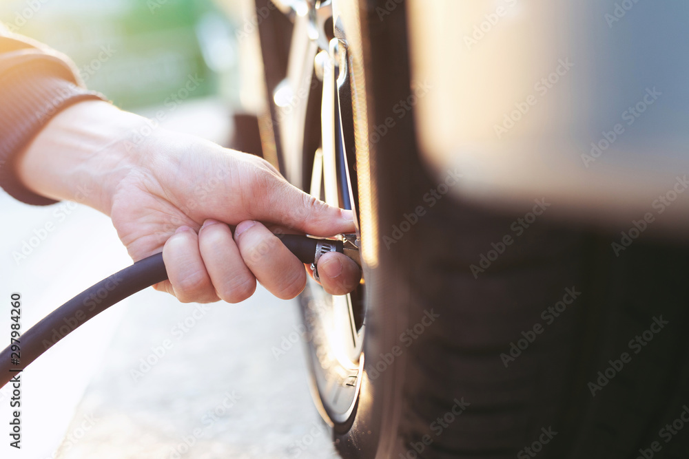 Poster close up hand man car parking a check and inflate the tire fill ...