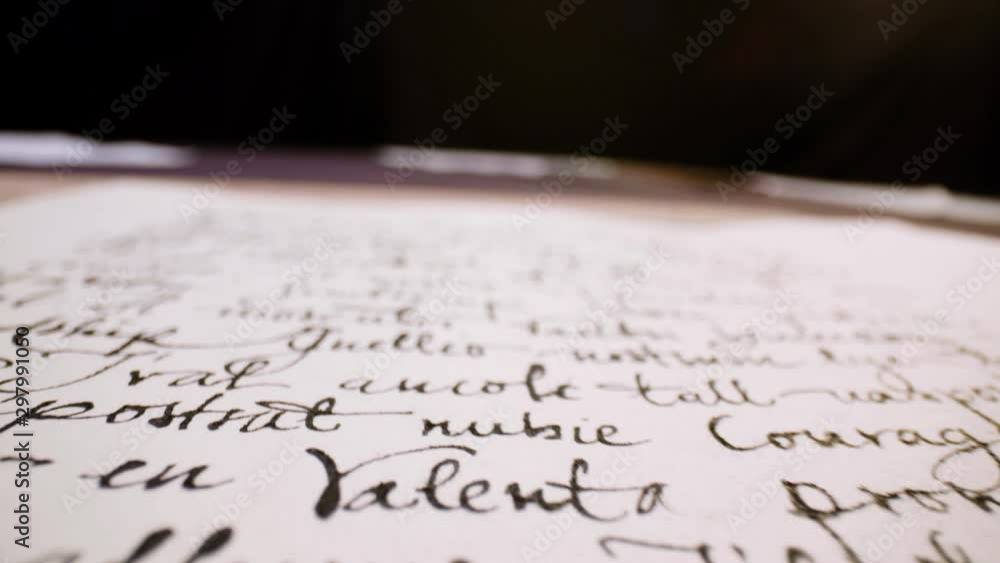 Calligraphy in slow motion. Pan shot of hand written page. Vintage ink ...