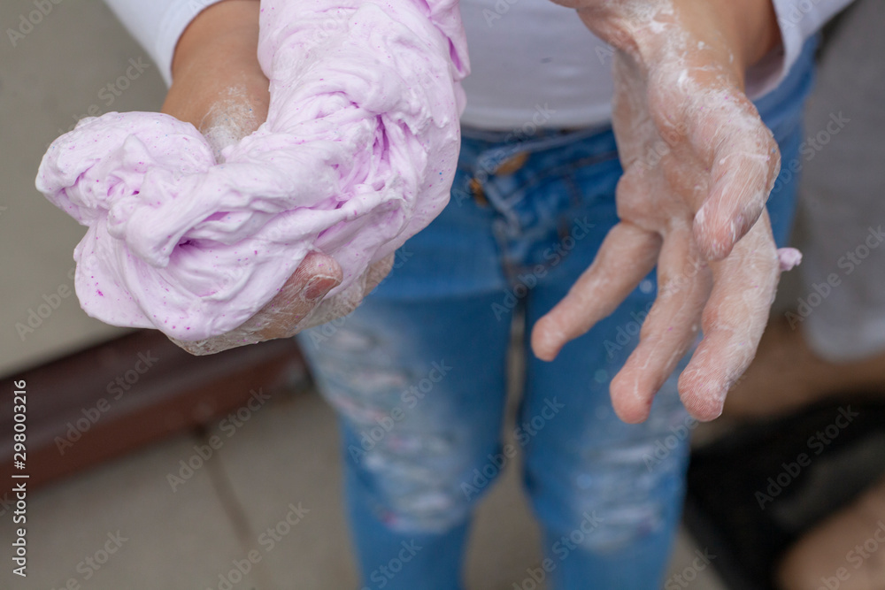 Sticky slime in the hand. The child wrinkles slime in his hands ...