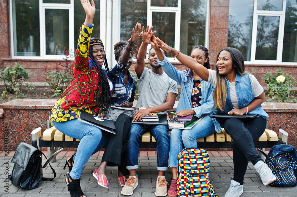 Group of five african college students spending time together on campus ...