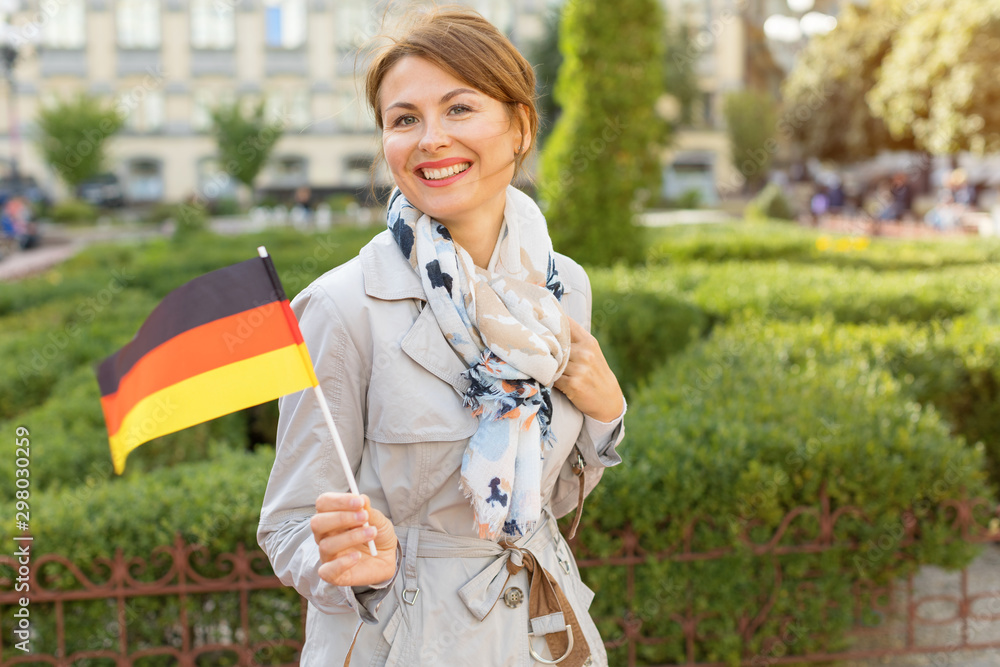 Happy middle aged woman with the German flag on a background of the ...