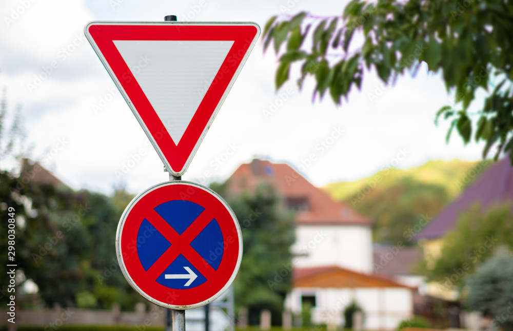 Two traffic sign on top of each other. A triangular sign means to pay ...