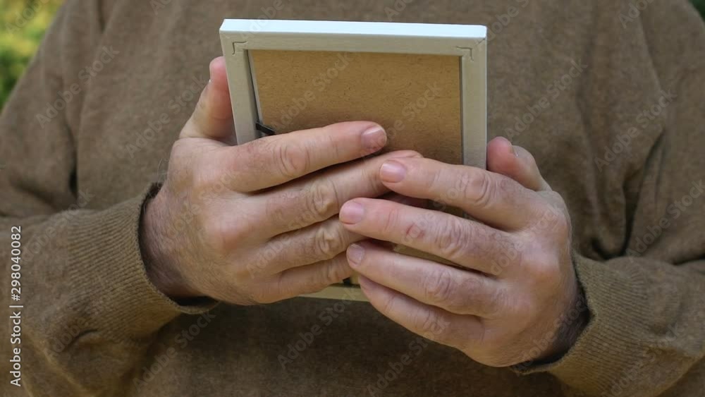 Aged male hugging photo missing children, sad widower remembering wife ...