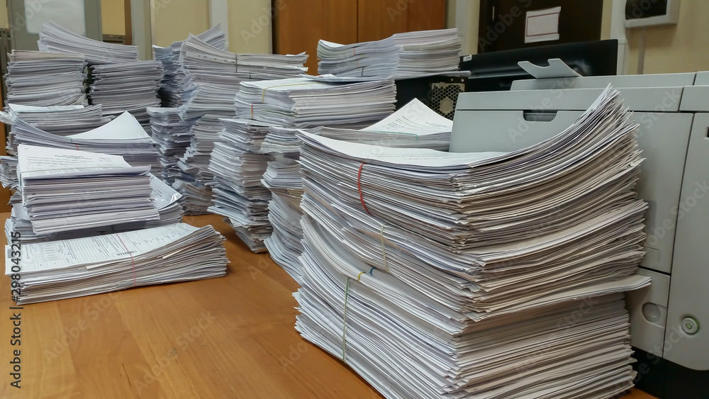 bundles bales of paper documents. stacks packs pile on the desk in the ...