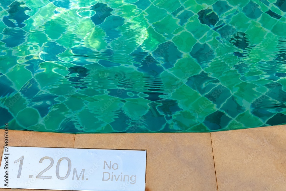 Swimming pool depth and no diving sign on the edge of outdoor pool for ...