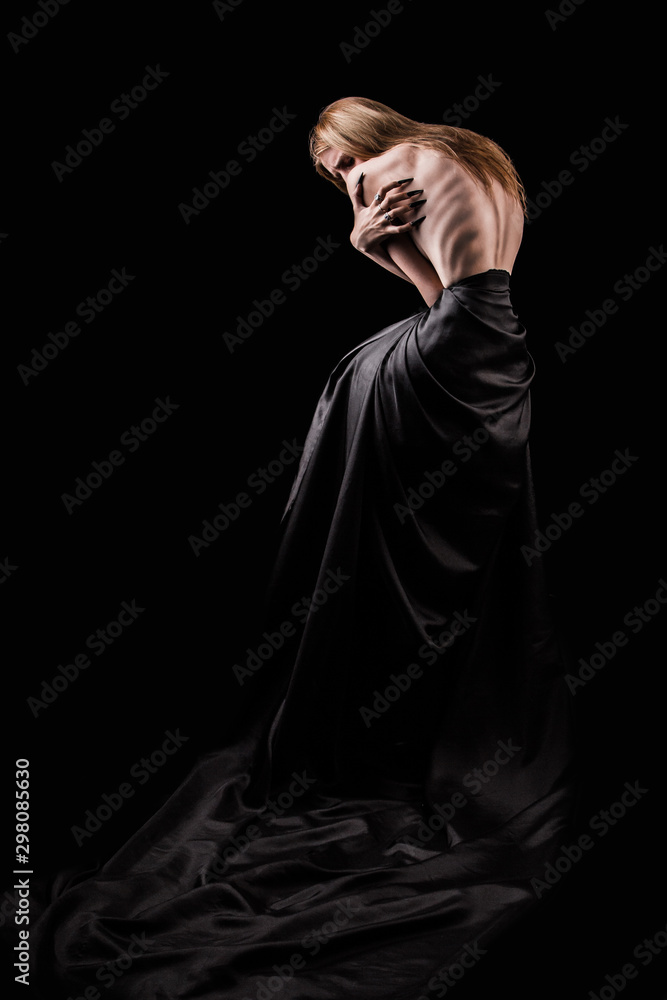 A girl with a bare back, severe thinness and protruding ribs. The ...