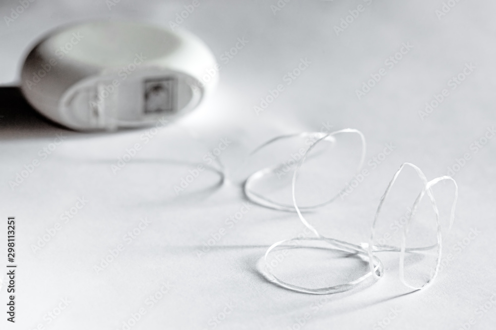 Dental floss. Tool for teeth hygiene. Concept of dental care. Black and ...