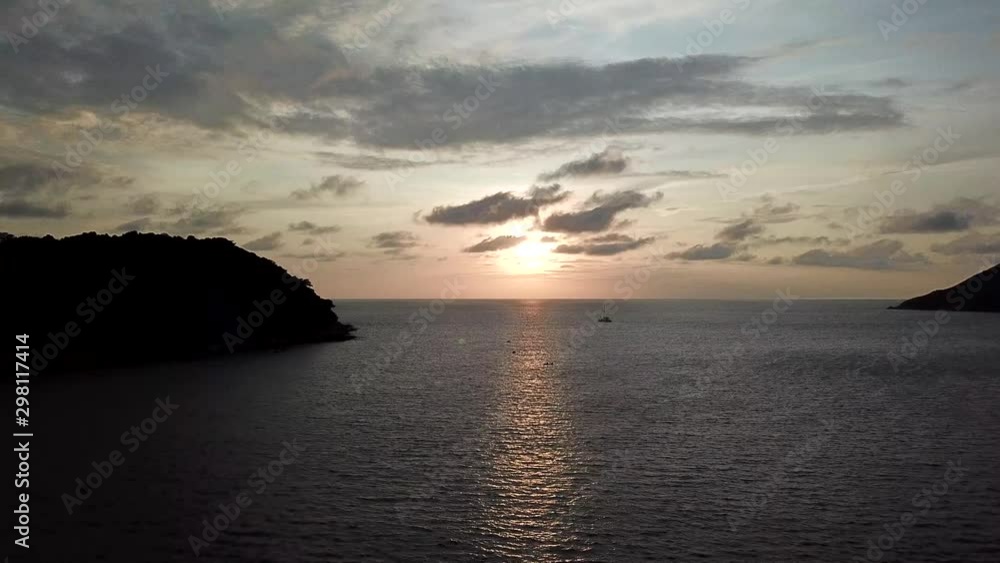 Sunset at the beach with island view, reflection on the sea looks ...