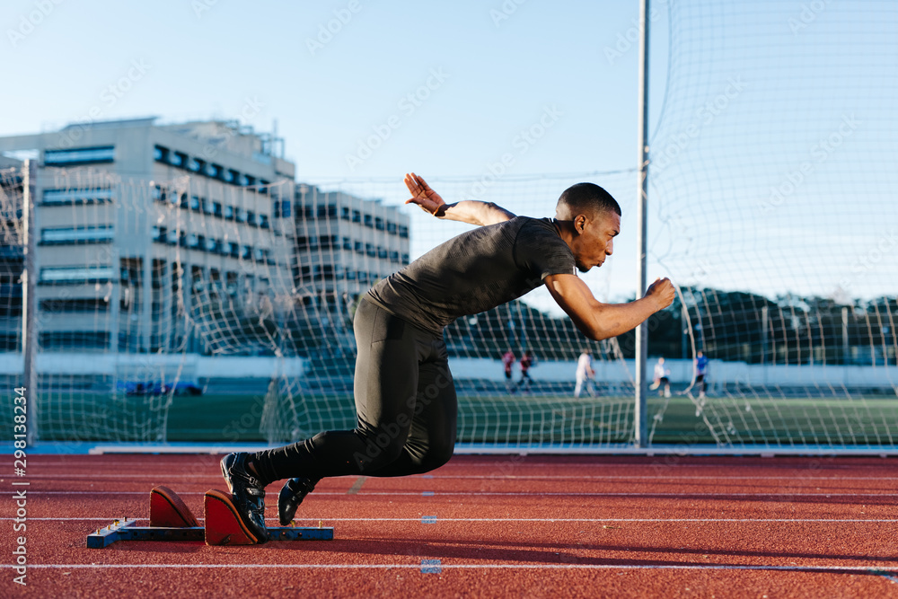 Black man running fast on stadium Stock Photo | Adobe Stock