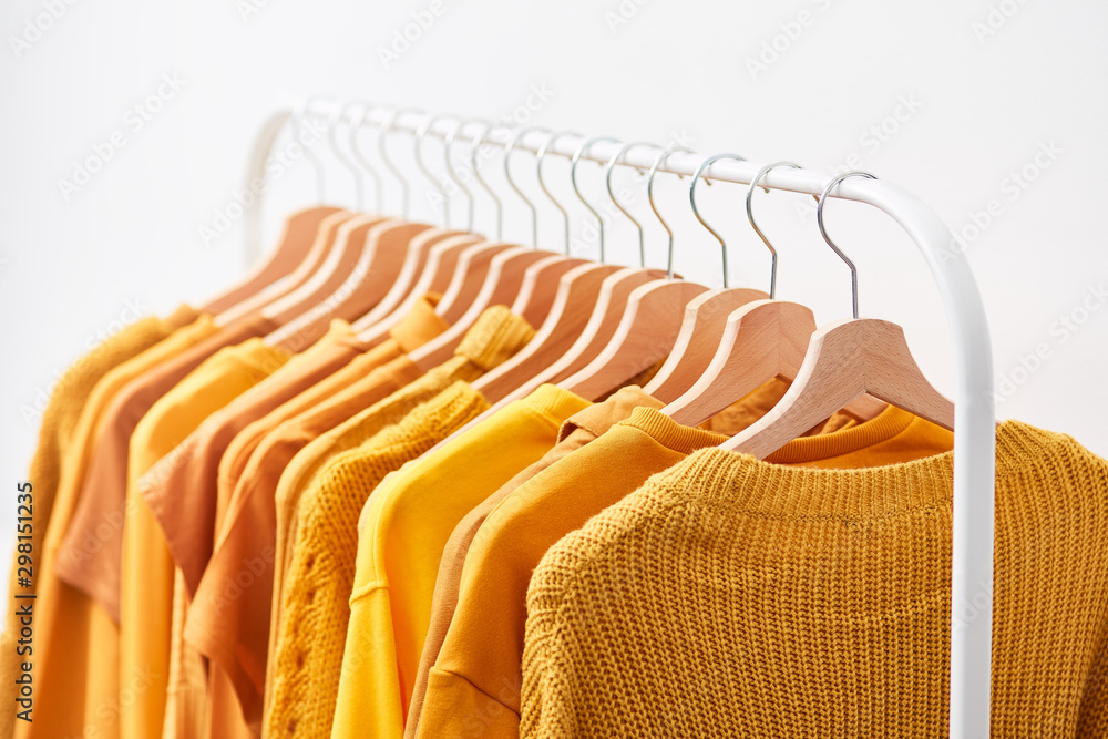 Clothes of yellow color on hangers Stock Photo | Adobe Stock
