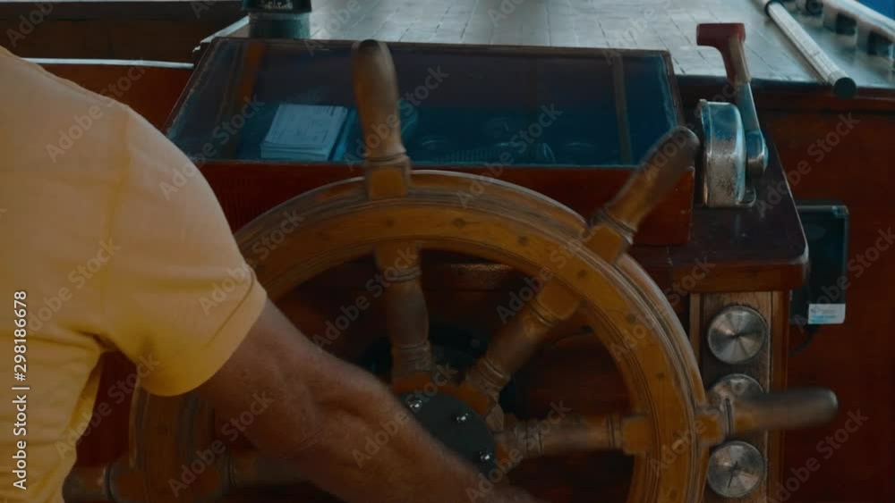 Cropped shot of captain helming ship with steering wheel. Close-up ...