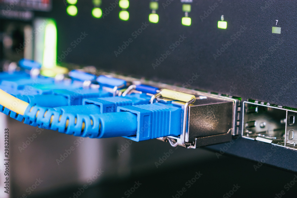 Fiber optic internet wires are connected to the ports of an access ...