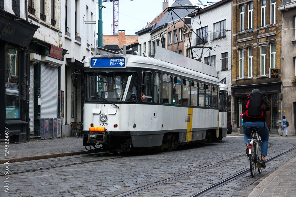 Antwerp old gothic street with railway for tram with reflect of light ...