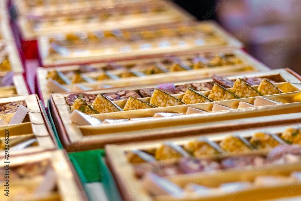A mixture of various Indian sweets packed in a box. Peda, laddu, mithai ...