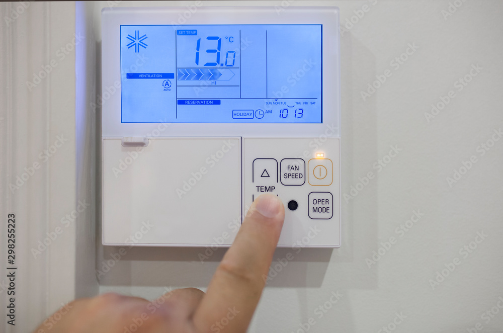 Adjusting room climate control with electronic device at home Stock ...