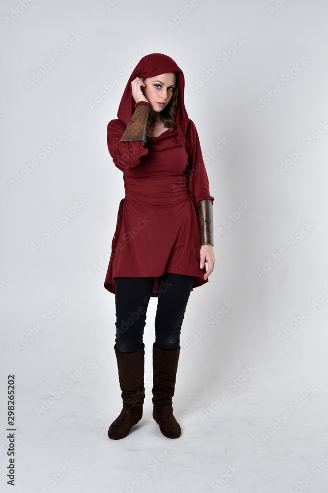 full length portrait of a brunette girl wearing a red fantasy tunic ...