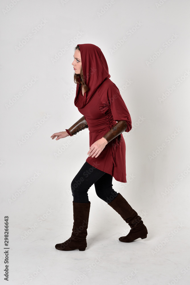 full length portrait of a brunette girl wearing a red fantasy tunic ...