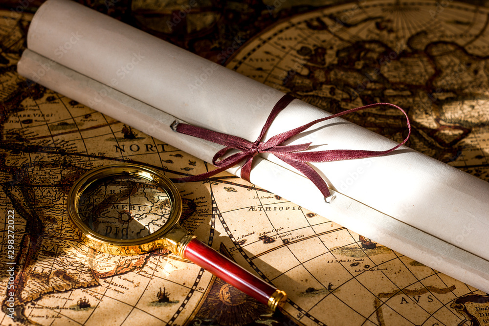 on a old vintage world map ice scroll and magnifying glass, tourism and ...