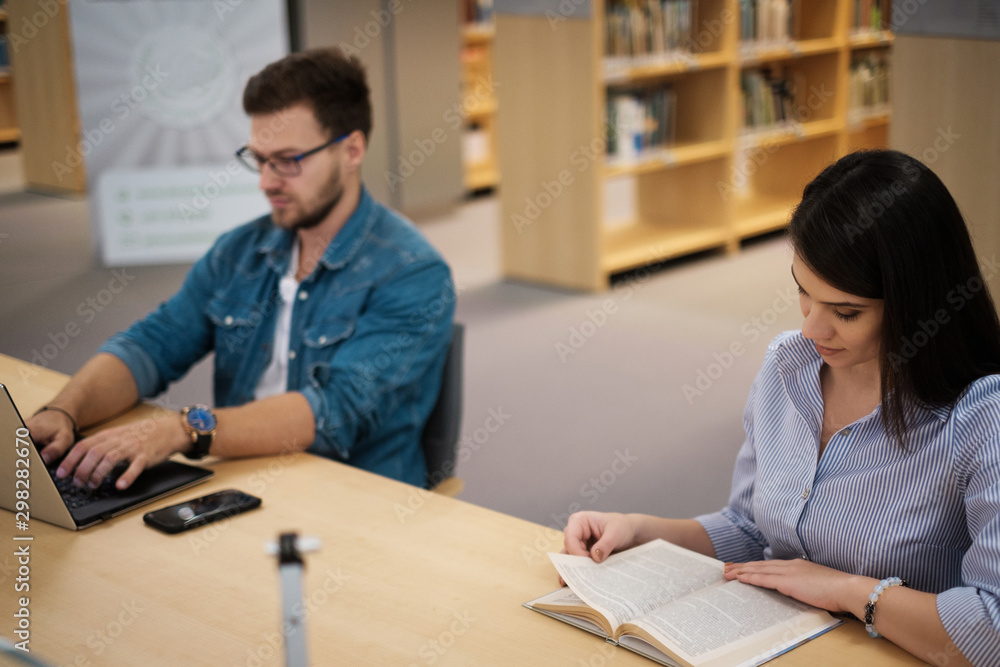 Students studying in a public library Stock Photo | Adobe Stock