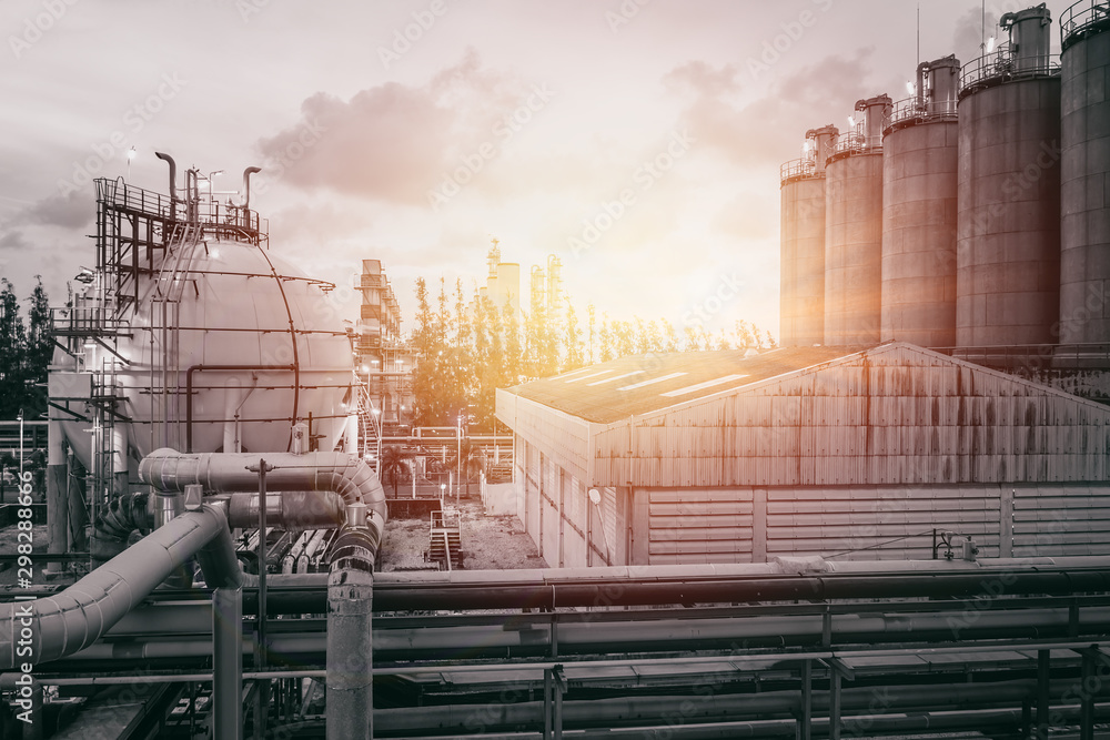 Storage tanks in warehouse on sunset sky background with vintage effect ...
