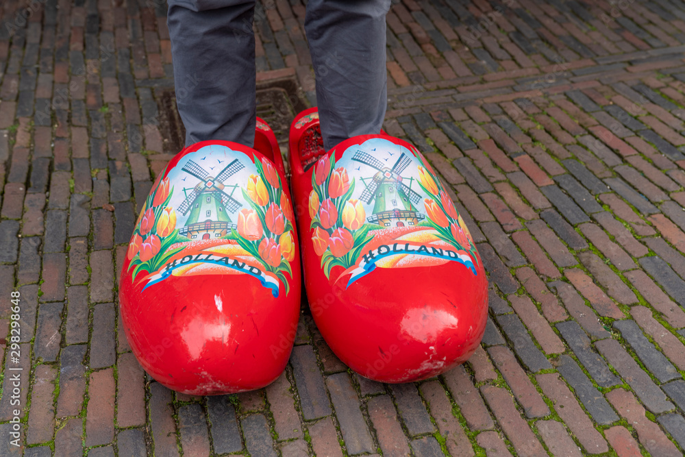 Big clogs with man's leg in Holland. Man try big clogs in Nederland ...