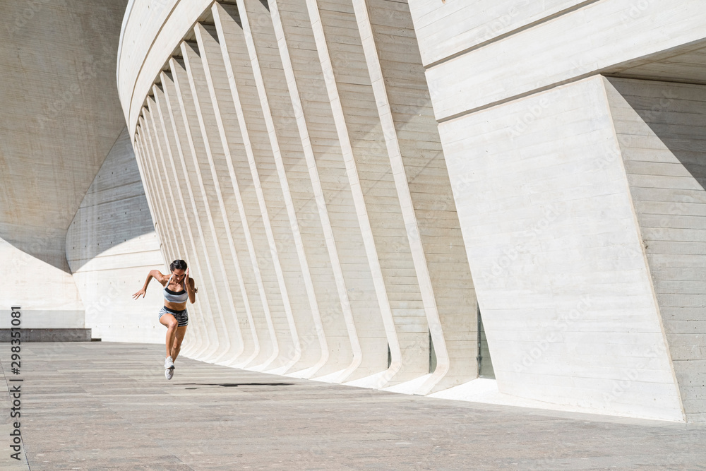 Pulled back view of female athlete running on concrete Stock Photo ...