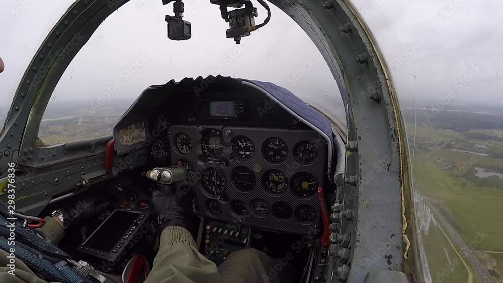 Hand of pilot hold and control helm. A gray combat aircraft flying. The ...