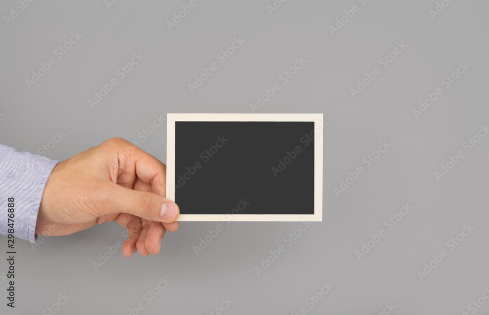 hand holding photo frame grey background Stock Photo | Adobe Stock