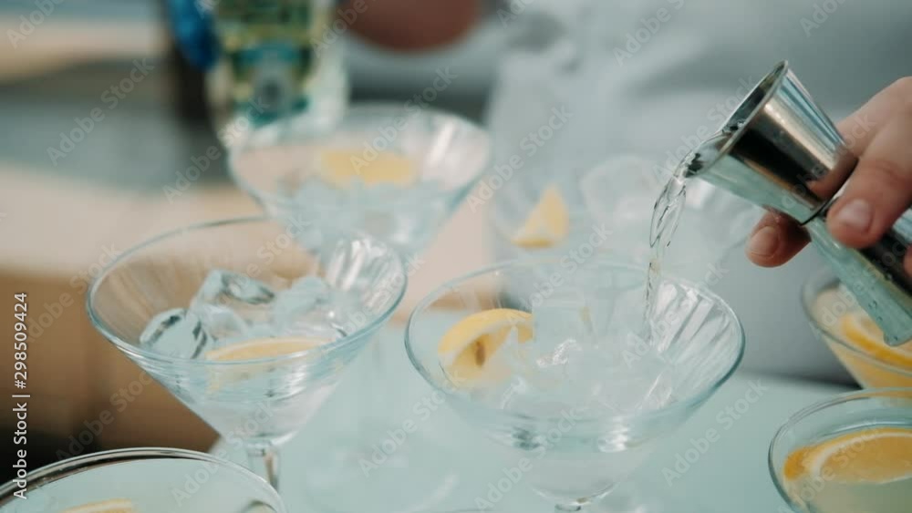The process of making a cocktail. Barman prepares a cocktail at the bar ...
