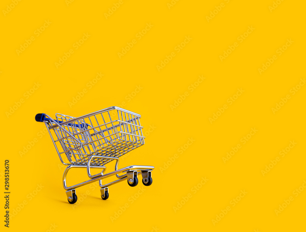 empty shopping cart over yellow background Stock Photo | Adobe Stock