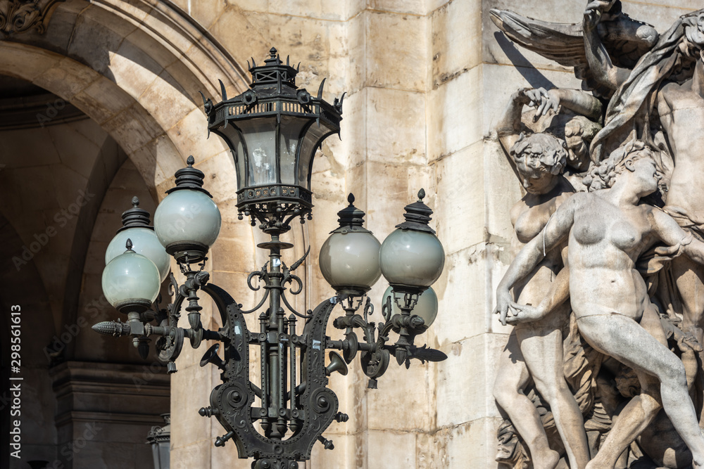 Ornate lamp post with multiple globes in front of old brick building ...