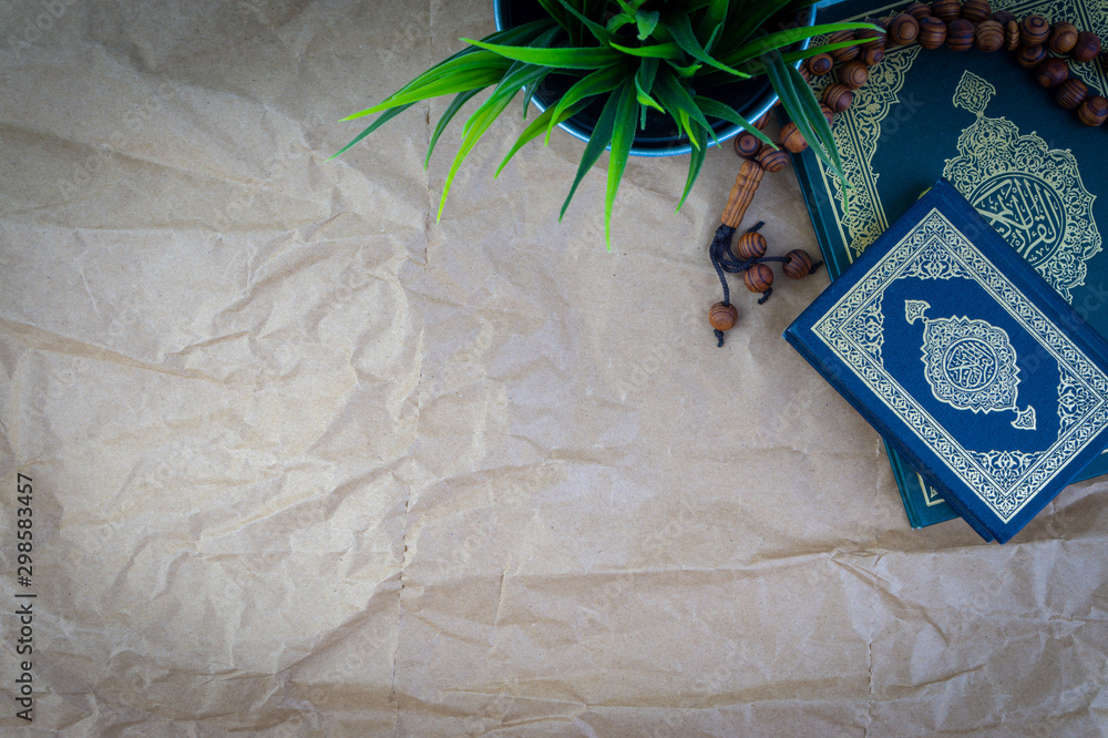 Flat lay Holy Quran with arabic calligraphy meaning of Al Quran and ...
