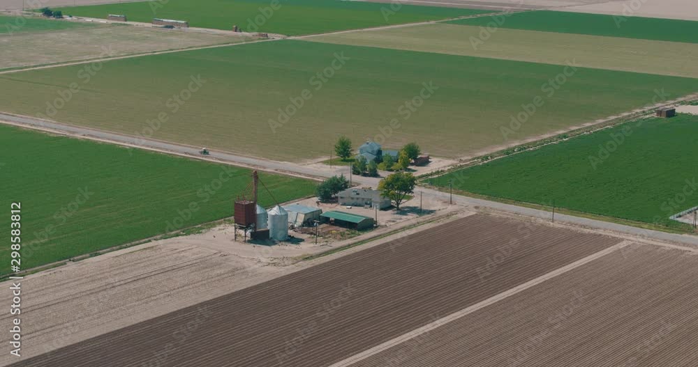 Drone aerial of rural farm area with barns and silos on country roads ...