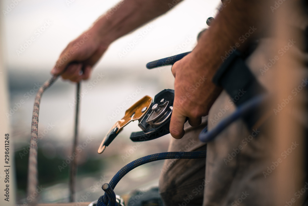 Side view picture of industrial rope access worker working at height ...