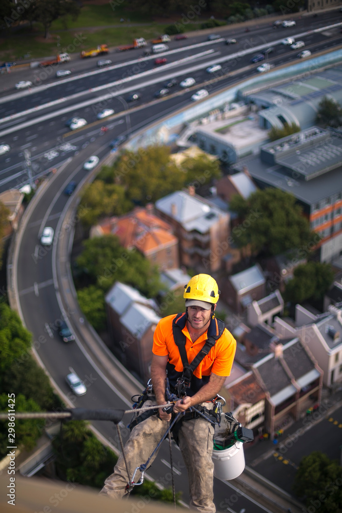 Abseiler maintenance wearing fall safety protection hard hat abseiling ...