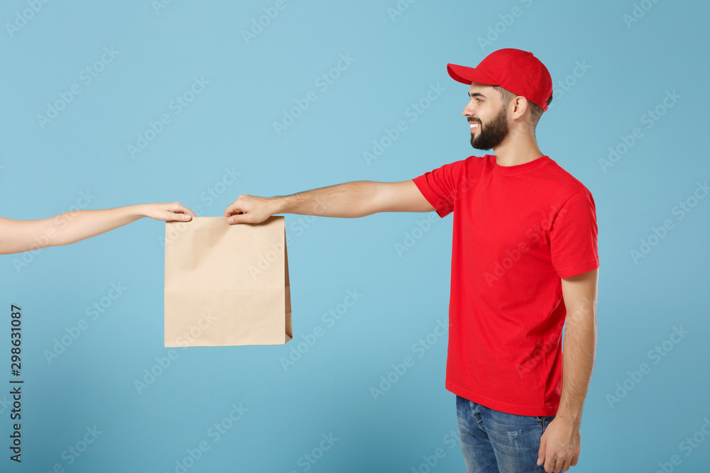 Delivery man in red uniform hold craft paper packet with food isolated ...