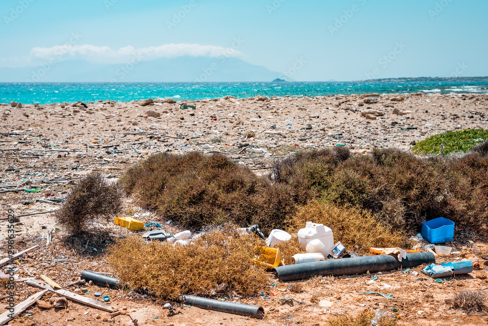 Plastic objects such as bottles, wrappers and balloons on a beach in ...