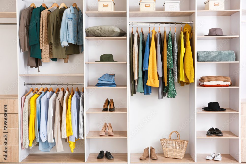 Big wardrobe with clothes in dressing room Stock Photo | Adobe Stock