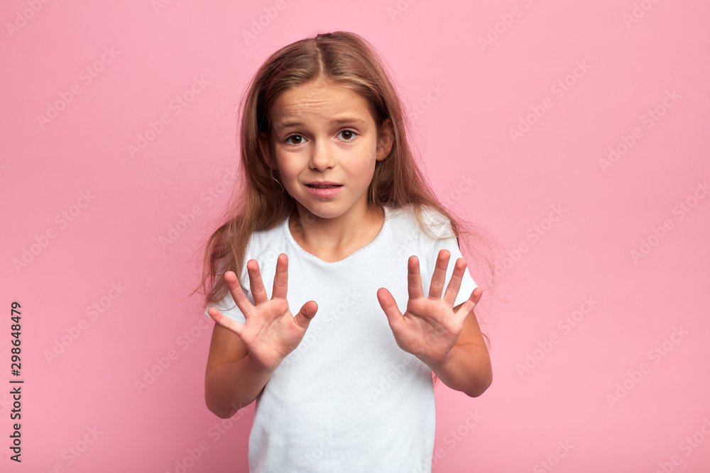 scared girl with raised palms looking at the camera with fear ...